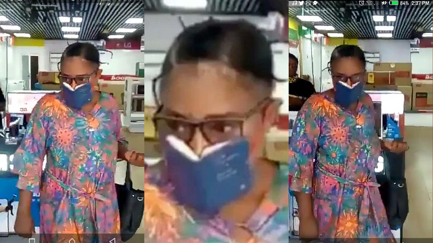 Woman seen using a mini Bible as a face mask against the novel ...